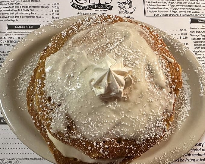 This isn't just a pancake—it's a golden cloud dusted with powdered sugar and topped with a dollop of heaven. Breakfast or dessert? Yes.
