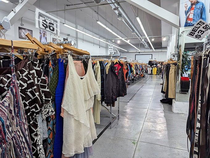 That ceiling-high clothing display isn't just storage—it's fashion art that would make any museum jealous indeed.