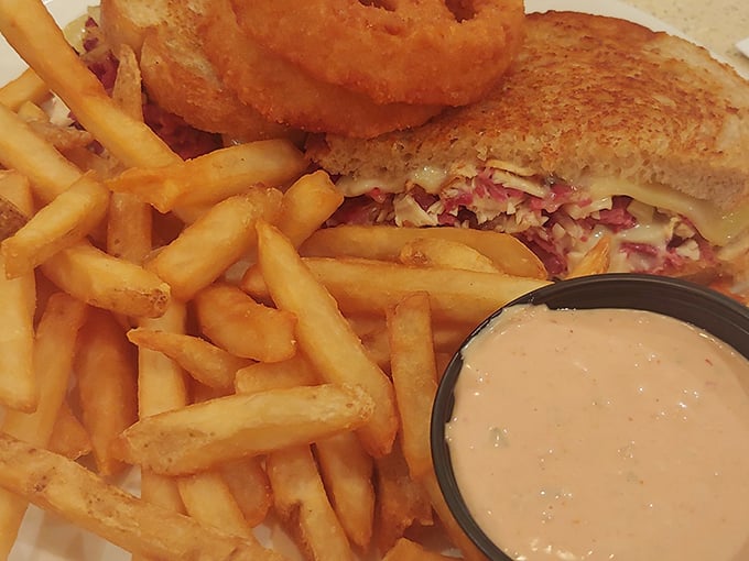 This isn't just a sandwich—it's architecture on a plate. Crispy, gooey, savory perfection with fries that deserve their own fan club.