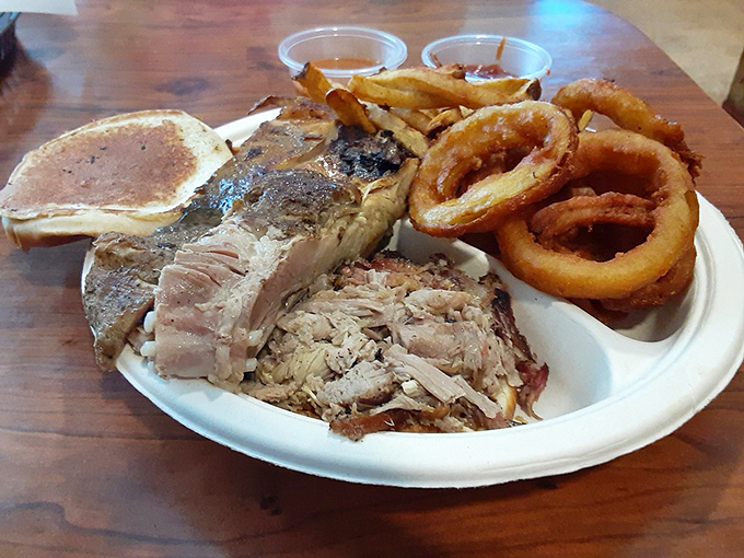 A barbecue plate that doesn't mess around—tender smoked meat alongside golden onion rings that shatter with each bite.