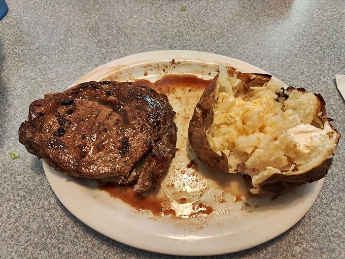 This ribeye doesn't need fancy plating to impress. The juicy steak and perfectly fluffy potato speak a universal language of satisfaction.