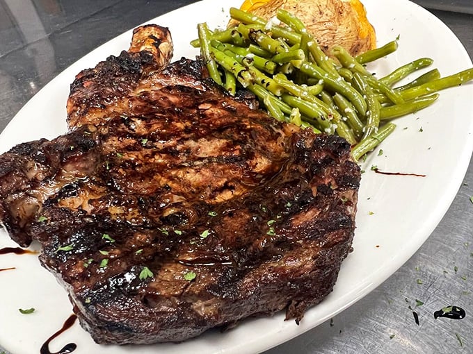This isn't just a steak, it's a declaration of carnivorous intent—a perfectly charred ribeye that makes vegetarians question their life choices.