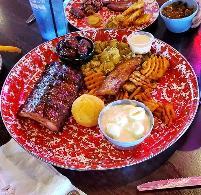 BBQ nirvana on a plate – ribs with that perfect smoke ring, sides that know their supporting role, and a cornbread muffin standing by for sauce duty.