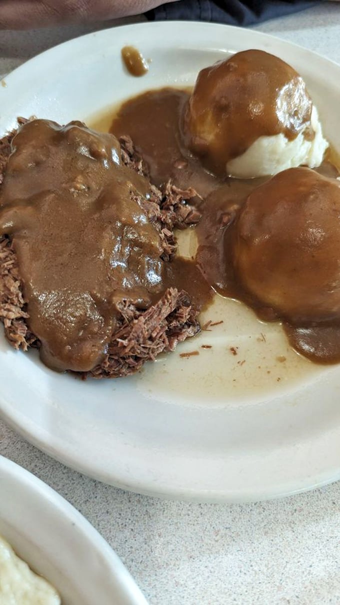 Roast beef that doesn't need Instagram filters—tender, slow-cooked meat swimming in rich gravy alongside pillowy mashed potatoes. Comfort defined.