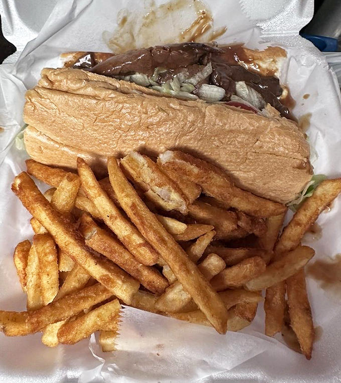 This roast beef po-boy isn't just a sandwich – it's a gravity-defying masterpiece of tender meat and gravy that requires strategic eating techniques.