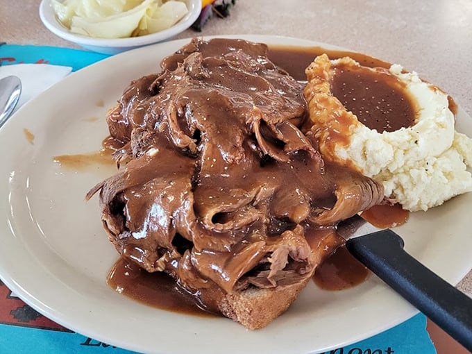 The hot beef sandwich—where gravy isn't just an option, it's a lifestyle choice that smothers your worries along with the bread.