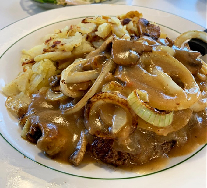 Salisbury steak swimming in savory gravy with those perfectly caramelized onions—TV dinners of your childhood just called to apologize for the comparison.
