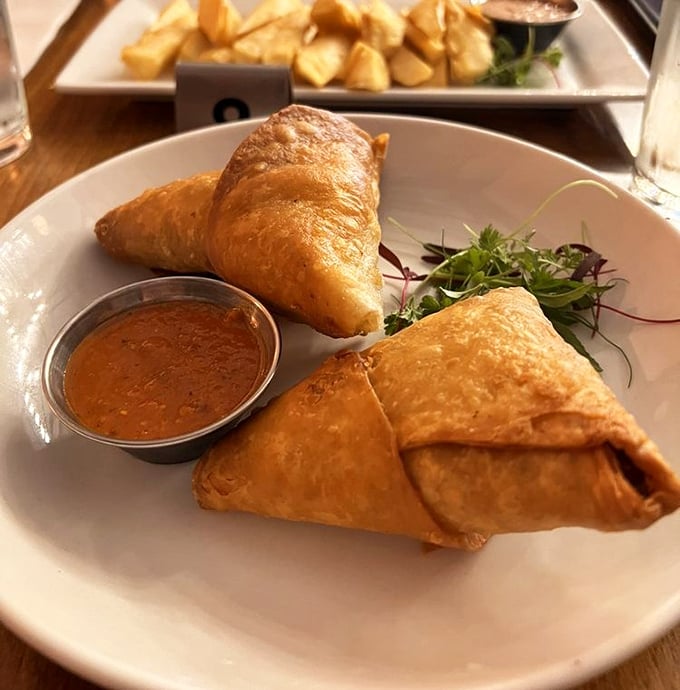 Golden, flaky samosas that crackle with each bite, revealing savory treasures inside – the Indiana Jones of appetizers.