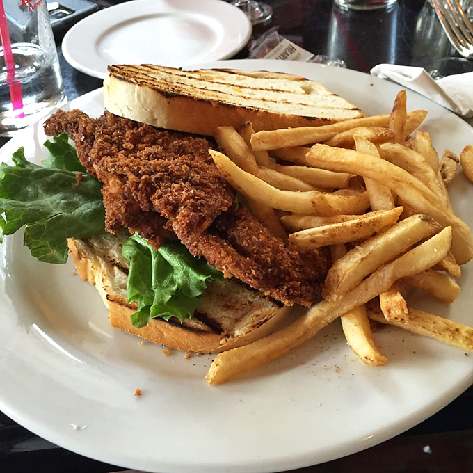 Not just any sandwich—a masterclass in crunch, with perfectly fried fish nestled between grilled bread and accompanied by hand-cut fries.
