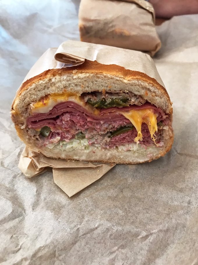 Layer upon glorious layer of meat and cheese, this sandwich doesn't just satisfy hunger—it creates a momentary state of bliss that transcends ordinary lunch.