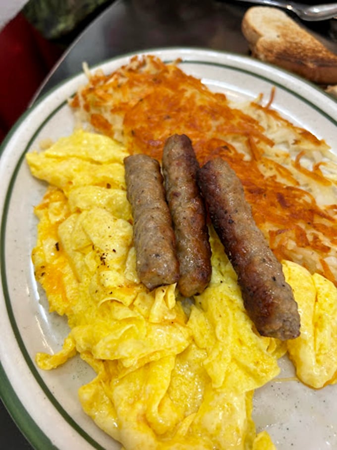 Breakfast doesn't get more American than this—golden scrambled eggs, perfectly browned sausage links, and hash browns with that ideal crispy-to-fluffy ratio that science still can't explain.