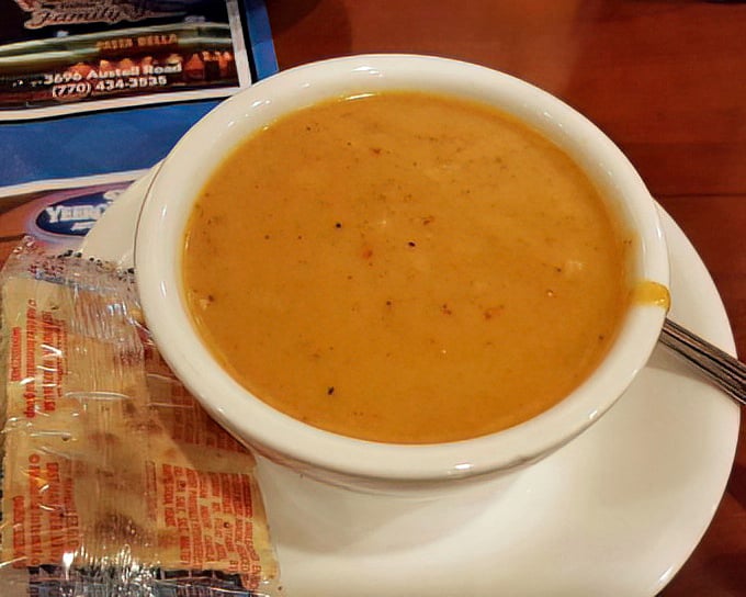 The seafood bisque arrives like a warm hug in a bowl, rich and comforting with flavors that whisper tales of the ocean.