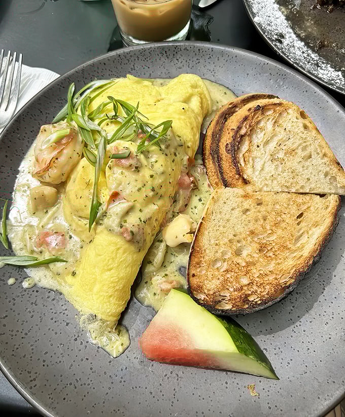 This isn't just an omelet—it's a seafood symphony on a plate, with perfectly toasted bread standing by for the inevitable "clean your plate" moment.