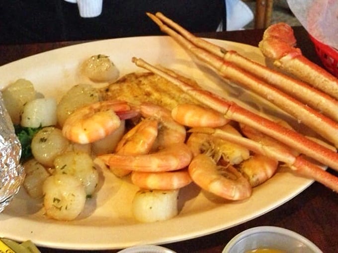 A seafood platter that would make Neptune himself jealous—plump shrimp, tender scallops, and crab legs stretching toward seafood nirvana.