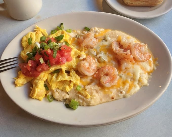 Southern comfort reimagined—creamy grits playing host to plump shrimp while eggs and fresh tomatoes add pops of color and flavor.