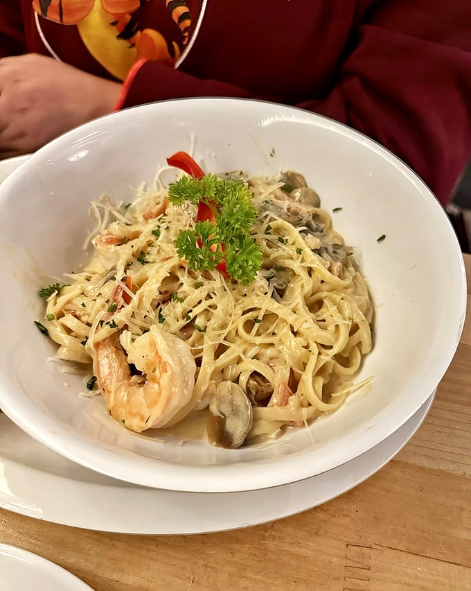 Pasta that doesn't just have seafood in it, but seems to celebrate it – shrimp and clams dancing through creamy strands like they're having their own little party.