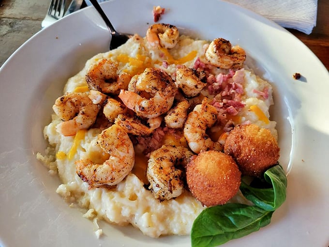 Shrimp and grits elevated to an art form – plump Georgia shrimp nestled on cheesy grits with what appears to be a hush puppy standing guard.