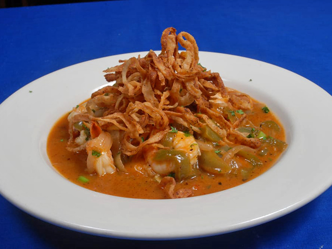 Shrimp and grits elevated to an art form. Those crispy onions aren't just garnish—they're the exclamation point on a Southern classic reimagined.