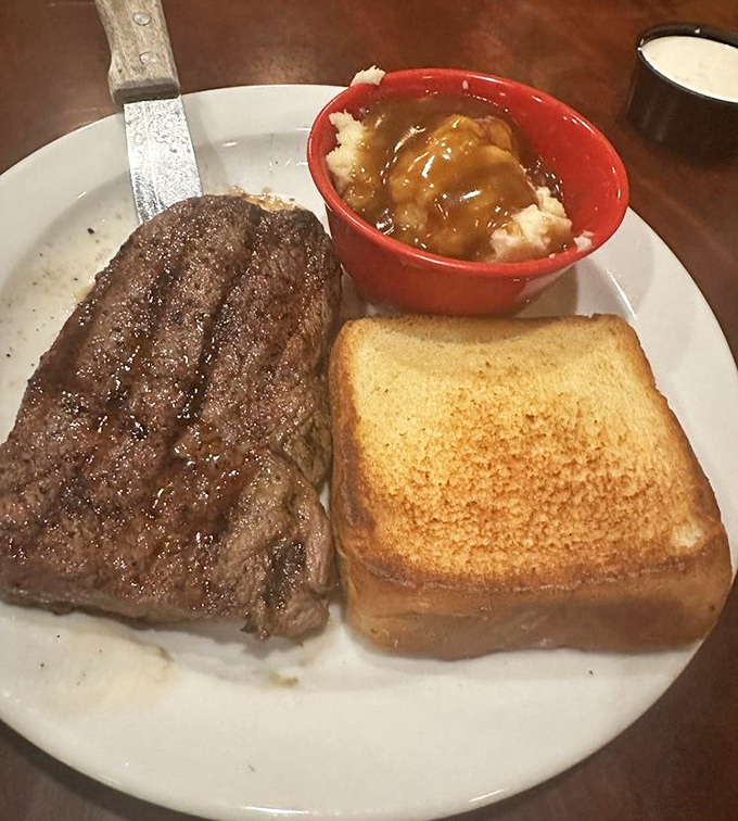 A perfectly grilled steak, a side of mashed potatoes with gravy, and Texas toast—the holy trinity of comfort food that never goes out of style.