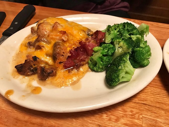 Smothered chicken that doesn't know when to quit—cheese, bacon, and mushrooms creating a flavor party that broccoli can only watch from the sidelines.
