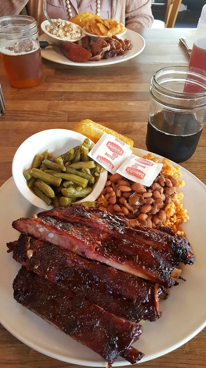 These ribs don't just fall off the bone – they practically leap into your mouth with that glistening bark that BBQ dreams are made of.