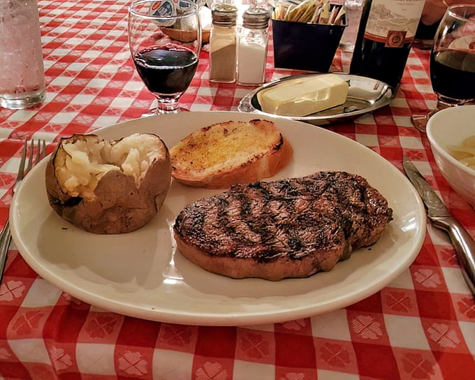 When your steak arrives with a glass of red wine, it's not just dinner—it's a ceremony. This plate deserves a moment of silent appreciation before the first cut.