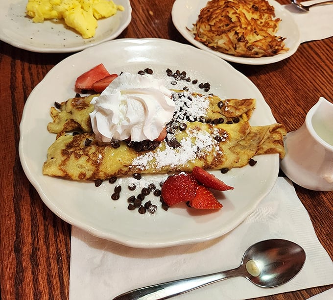 These crepes don't just hold strawberries and cream – they embrace them in a delicate pancake hug that makes fruit feel special.