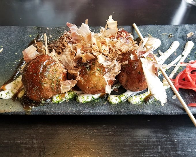 These takoyaki balls are the perfect three-bite wonder—crispy exterior giving way to a creamy center with tender octopus hiding inside.