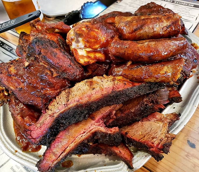 This isn't just a meat platter – it's a barbecue family reunion where ribs and brisket show off their smoke rings like proud badges of honor.