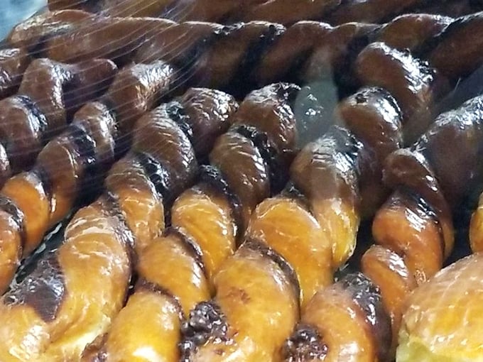 Tiger tails lined up like edible art—twisted perfection of chocolate and vanilla dough that makes you wonder why regular donuts don't come with stripes.