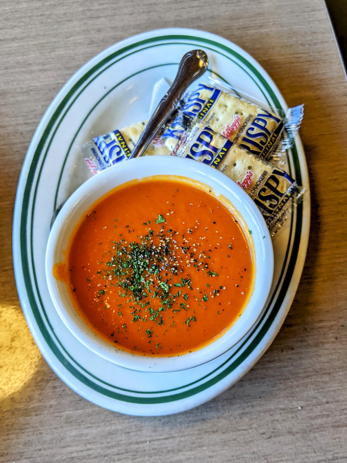 Tomato bisque that doesn't need a grilled cheese wingman—though those oyster crackers make charming dance partners.