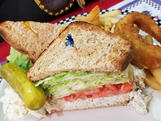 The humble tuna sandwich elevated to art form—crisp lettuce, ripe tomato, and creamy tuna salad between toasted bread that means business.