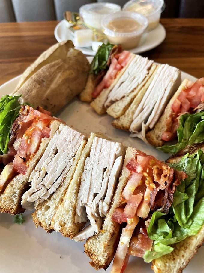 This isn't just a club sandwich—it's architecture. Layers of turkey, bacon, and fresh vegetables creating the skyscraper of sandwiches, with no permit required.