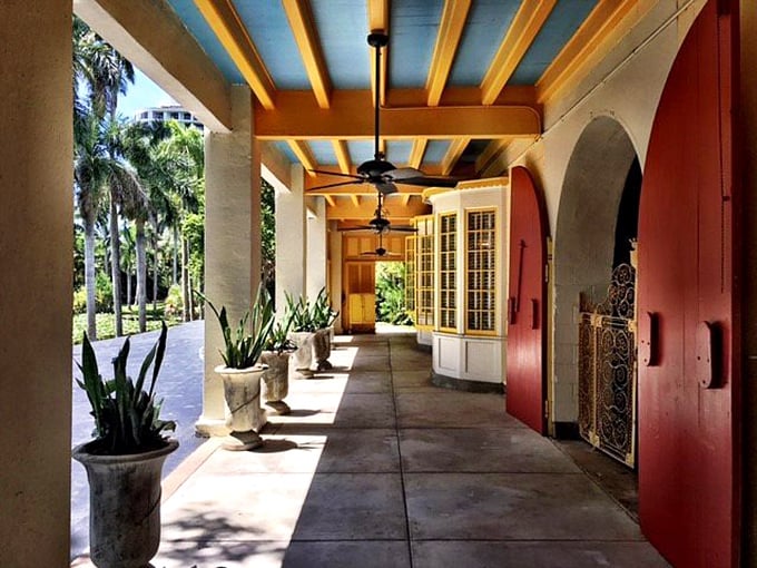 This breezy veranda with its terra-cotta doors and blue ceiling embodies the indoor-outdoor living that Floridians perfected long before it was trendy.