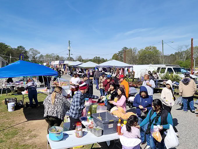 The crowd gathers around food vendors like a modern tribal ritual—because nothing builds shopping stamina like a paper plate of something delicious.