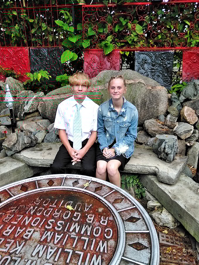 The stone bench offers visitors a moment of respite, while the circular medallion below hints at deeper meanings woven throughout this unusual sanctuary.