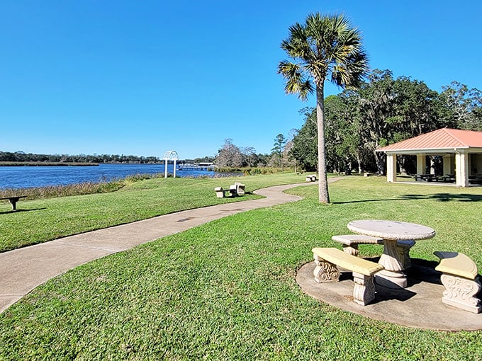 Picnic paradise along the riverbank—where the hardest decision you'll make all day is which bench offers the best water view.