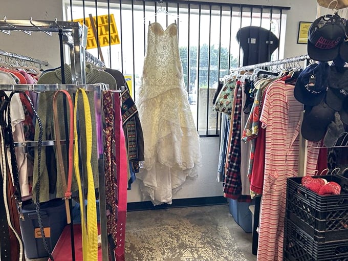 Between colorful everyday clothes hangs a wedding dress, patiently waiting for its next walk down the aisle or perhaps a creative Halloween costume.