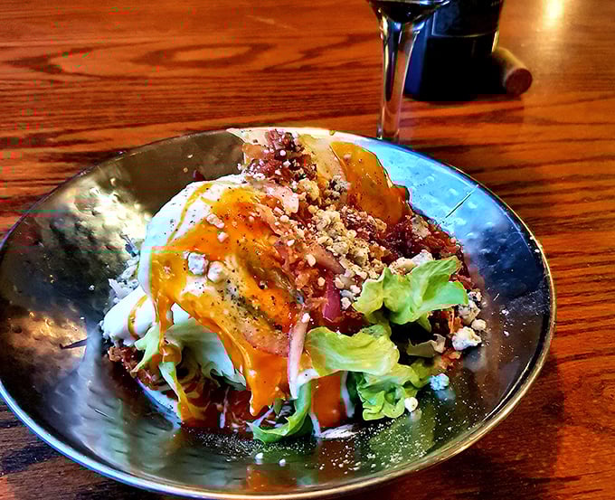 The wedge salad—that magnificent iceberg glacier drizzled with dressing and adorned with bacon bits—where "eating your vegetables" becomes a genuine pleasure.