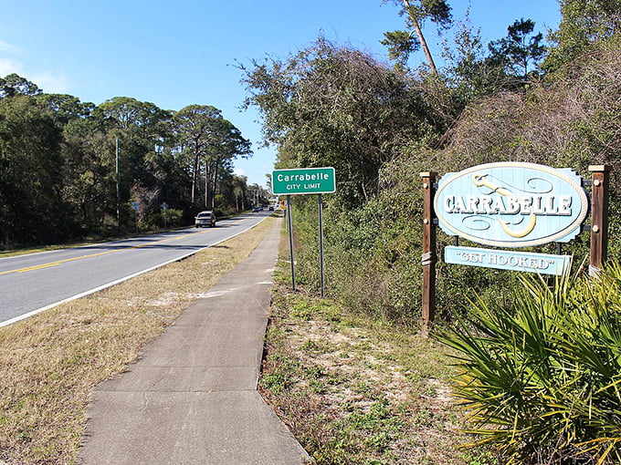 The "Not Forgotten" welcome sign greets visitors with the irony only small towns master – simultaneously announcing your arrival while promising you'll never be just another face.