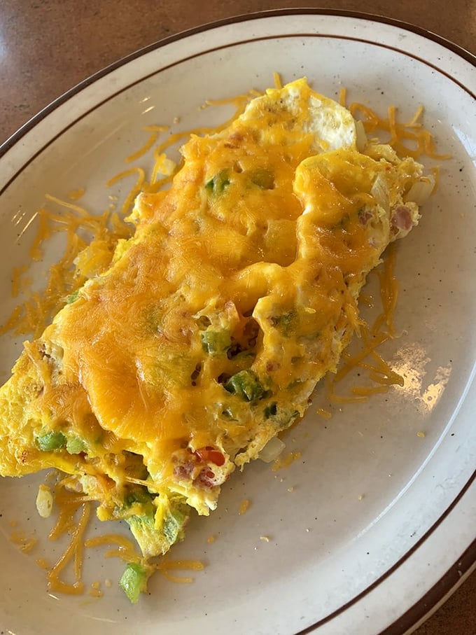 This Western Omelet isn't just breakfast—it's a sunrise fiesta of peppers, ham, and cheese that puts ordinary eggs to shame.