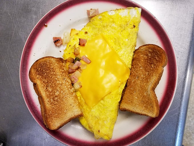 This cheese-laden omelet isn't just breakfast—it's edible sunshine on a plate, flanked by toast soldiers ready for yolk-dipping duty.