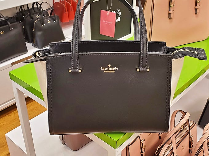 The Kate Spade handbag—sitting regally on its display, silently promising to transform you into someone who has their life together.