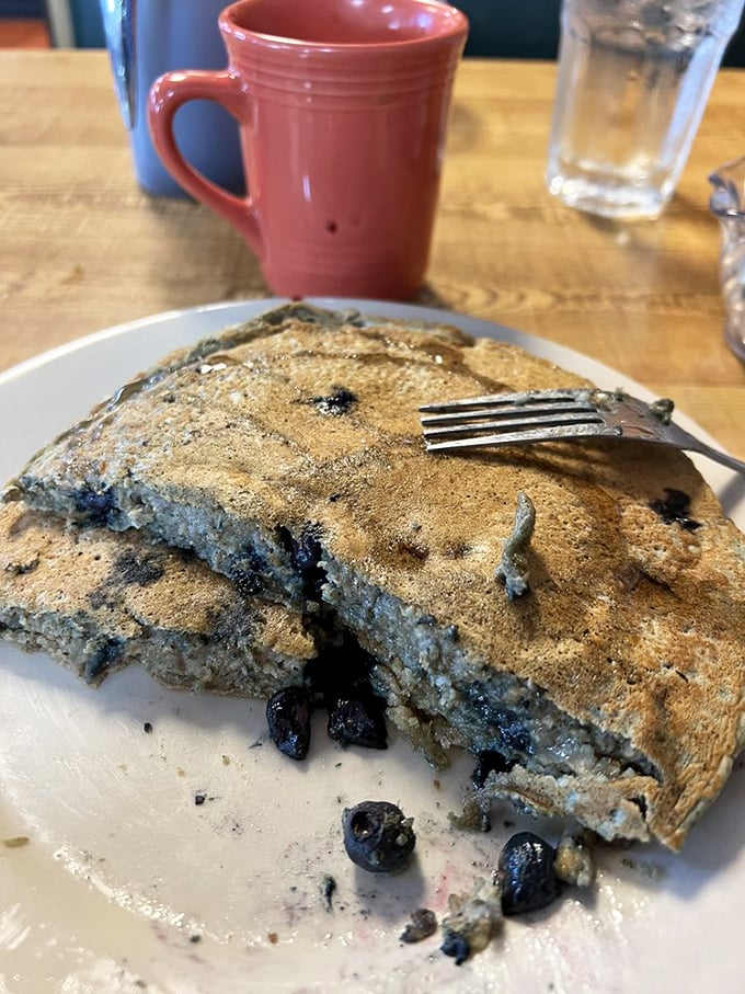 These blueberry pancakes don't just have berries—they've formed a delicious alliance that makes maple syrup sing with joy.