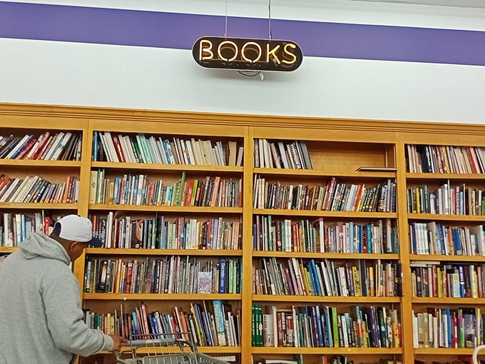 Under the glow of "BOOKS," wooden shelves stand tall, holding thousands of stories waiting for their next reader to come along.