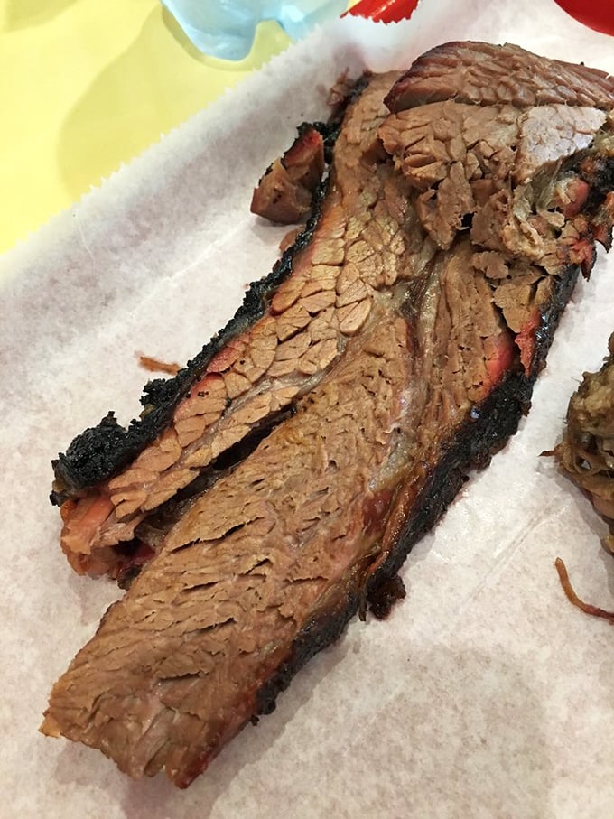 Brisket with that perfect bark and pink smoke ring—the holy grail of BBQ that makes Texans nod in respectful approval.