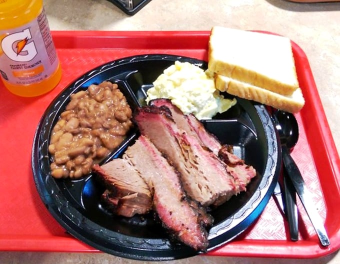 Brisket that's been kissed by smoke and time, served alongside beans and potato salad. This, friends, is what happiness looks like on a plate.
