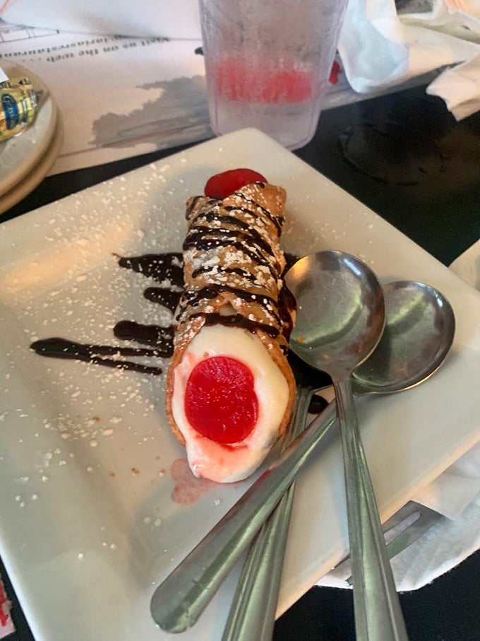 Not all heroes wear capes, but this cannoli wears a chocolate drizzle and cherry crown fit for Italian royalty.