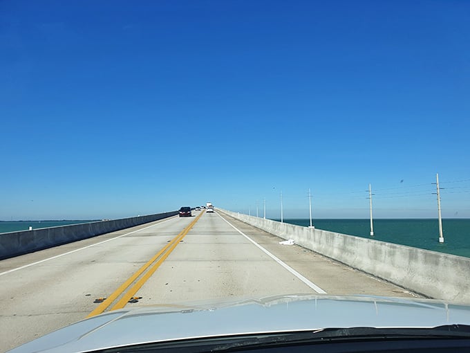 The road trip where the journey truly is the destination. Two lanes of possibility stretching across an impossible blue.