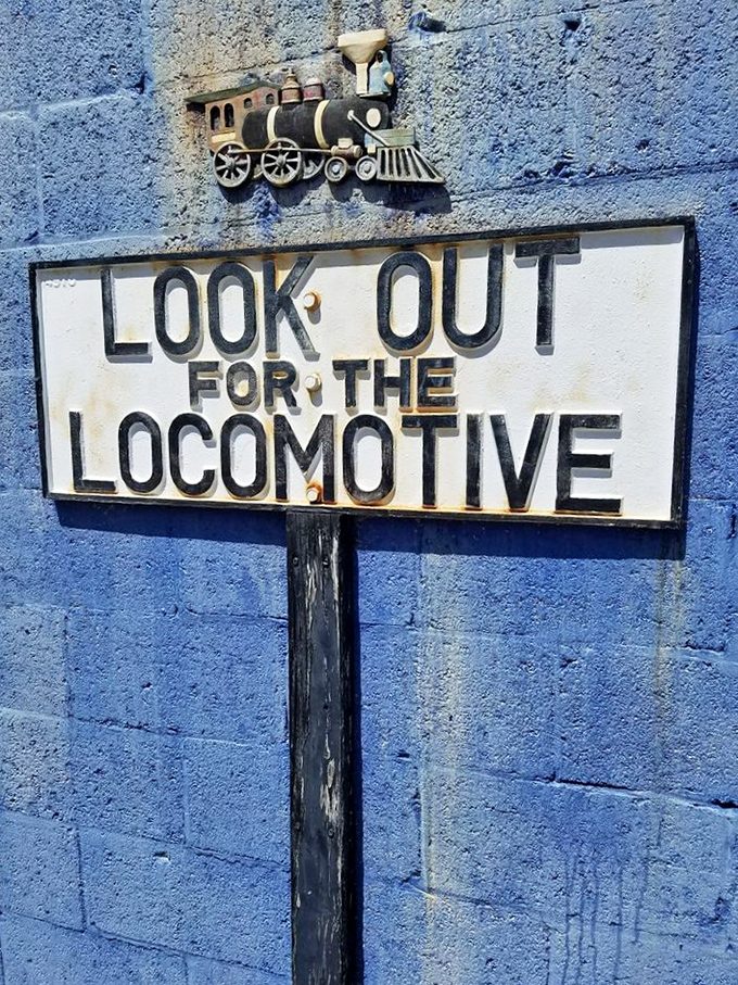 Look out for the locomotive—sage advice from this vintage railway sign that adds a touch of authentic railroad culture to the museum experience.